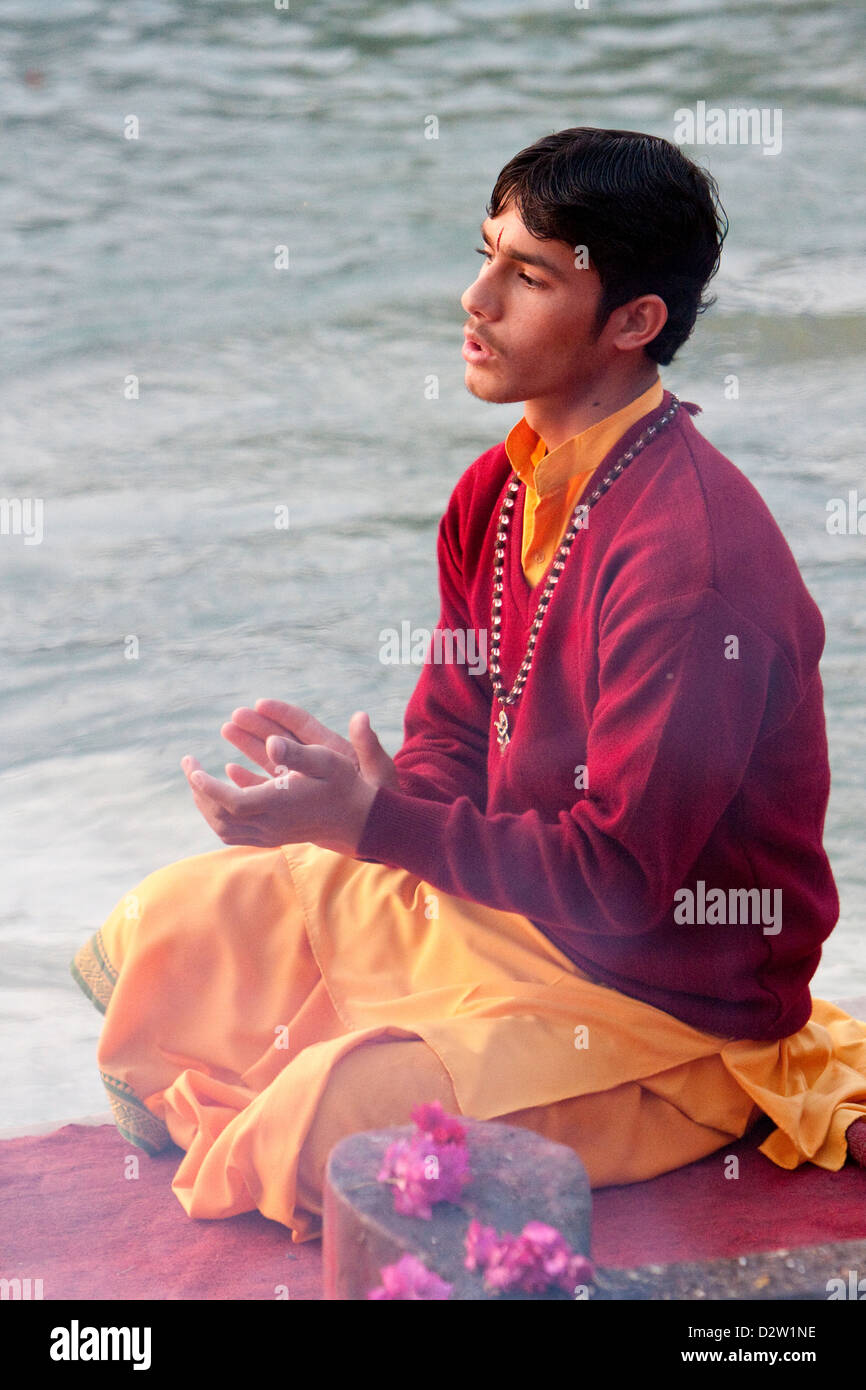 India, Rishikesh. Young Monk Praying Evening Prayer (Aarti) at the ...