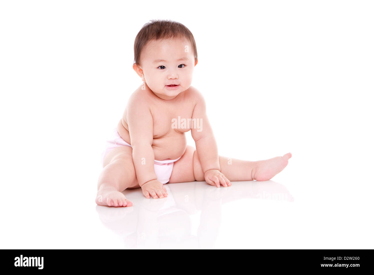 Studio shot of cute baby sitting on floor Stock Photo - Alamy