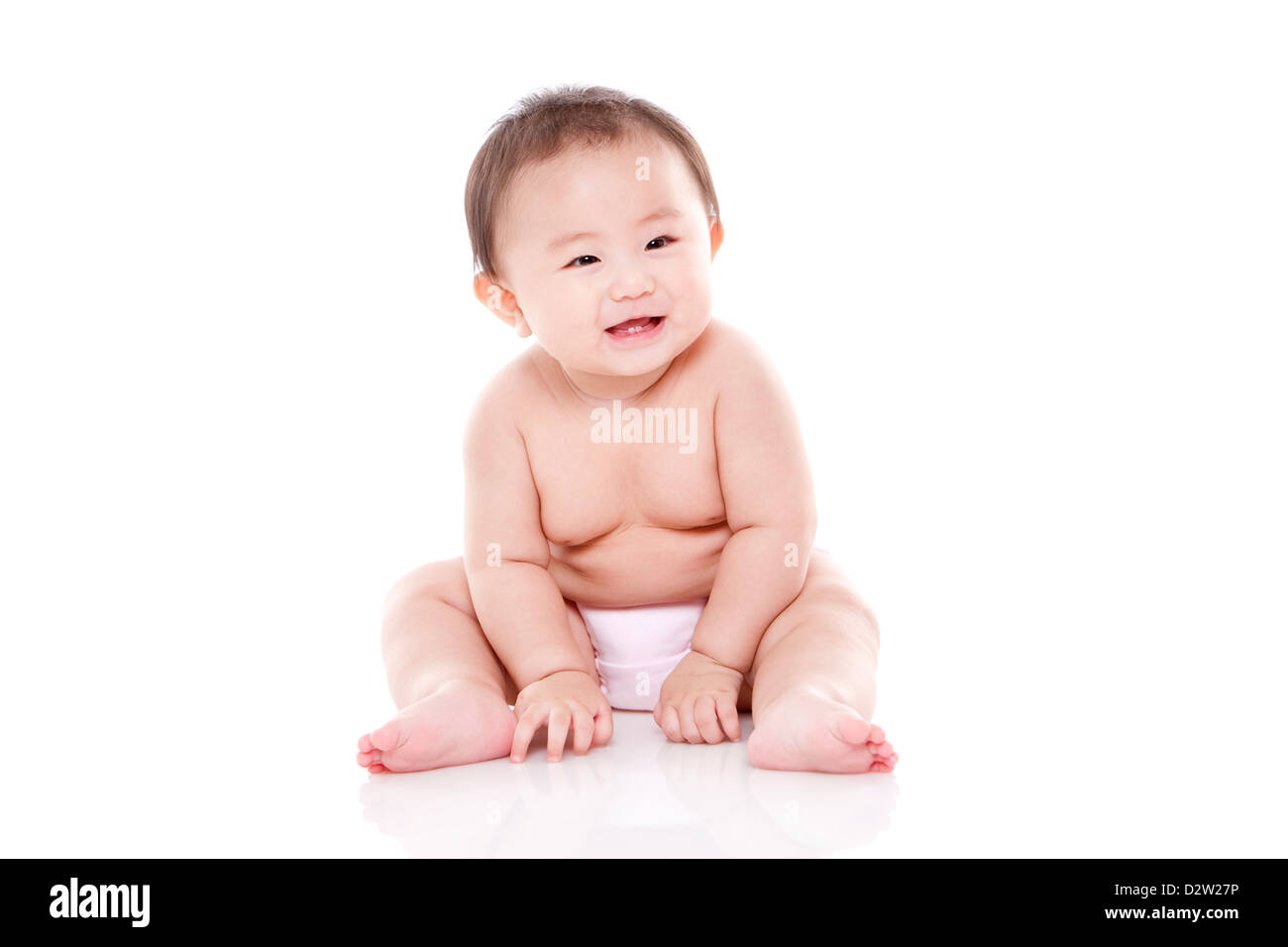 Studio shot of cute baby sitting on floor Stock Photo - Alamy