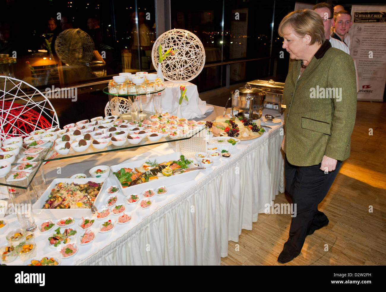 German Chancellor Angela Merkel (CDU) eats an appetiser from the buffet ...