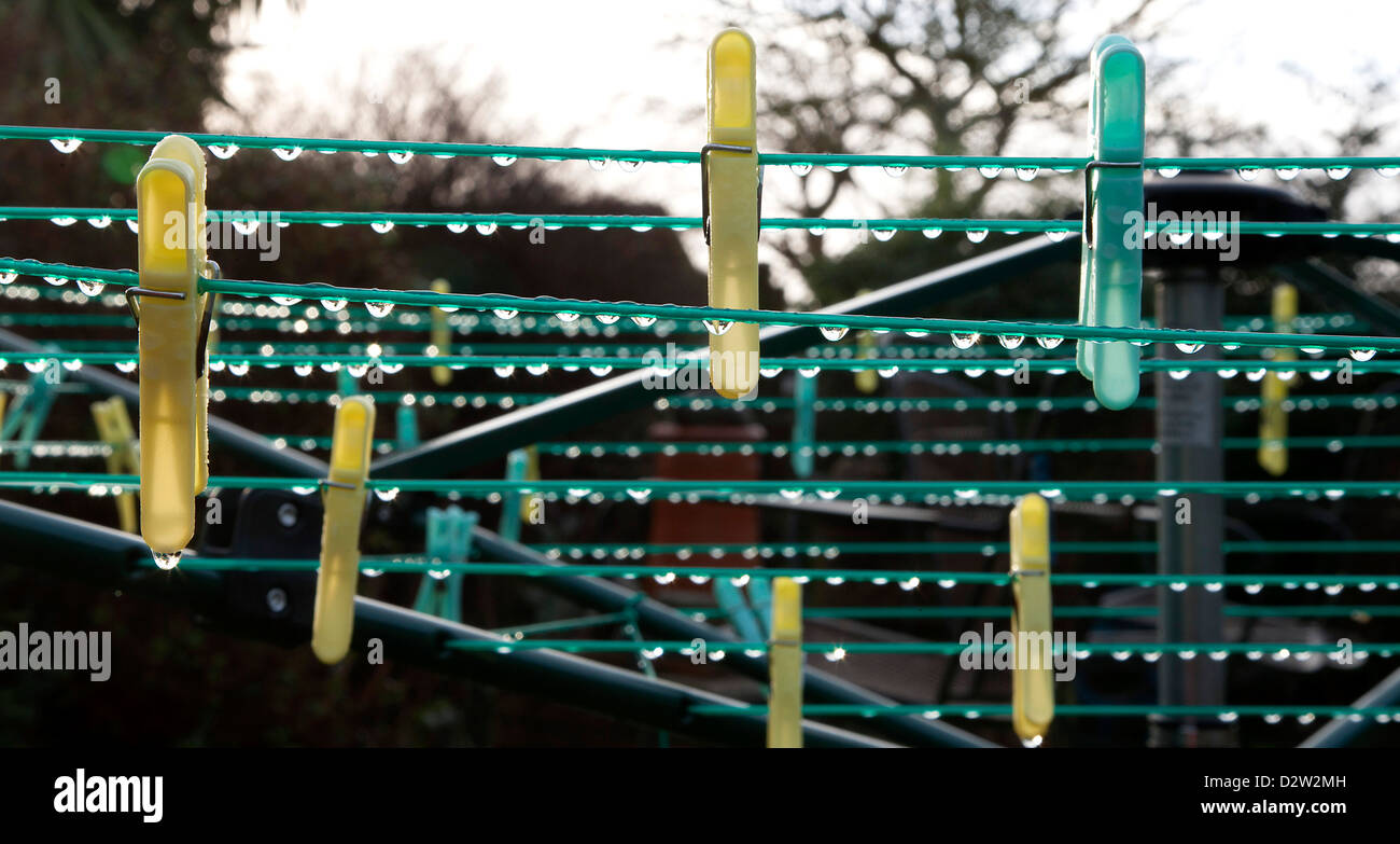 Clothes Pegs Pins on Wet Washing Line Stock Photo - Alamy
