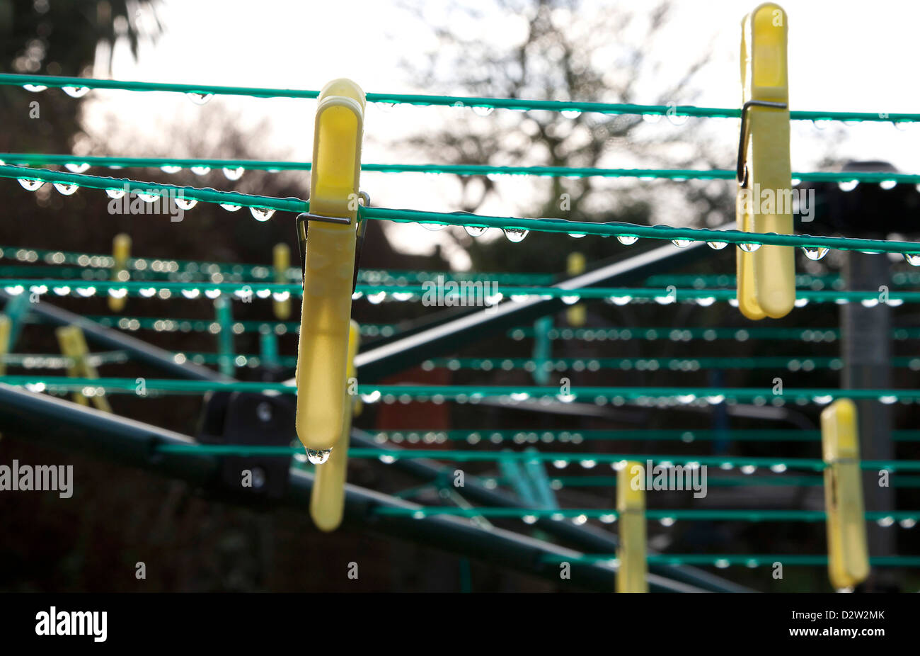 Clothes Pegs Pins on Wet Washing Line Stock Photo - Alamy