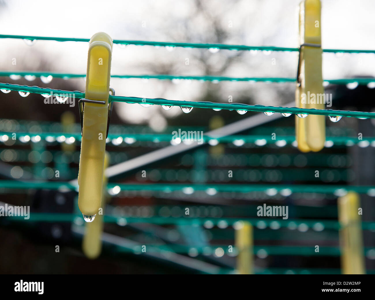 Clothes Pegs Pins on Wet Washing Line Stock Photo - Alamy