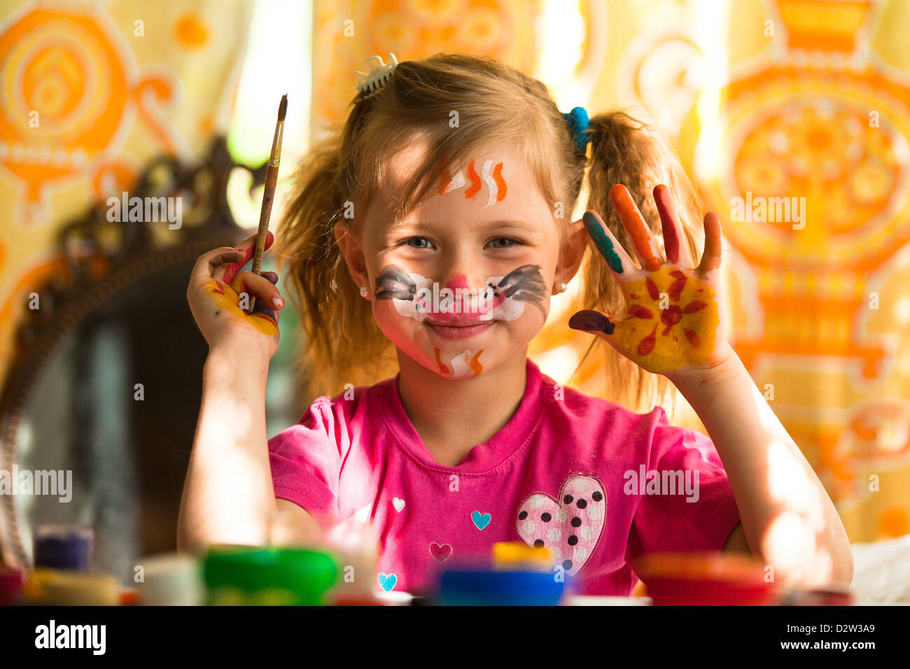 Little fanny girl drawing paint with paint of face Stock Photo - Alamy