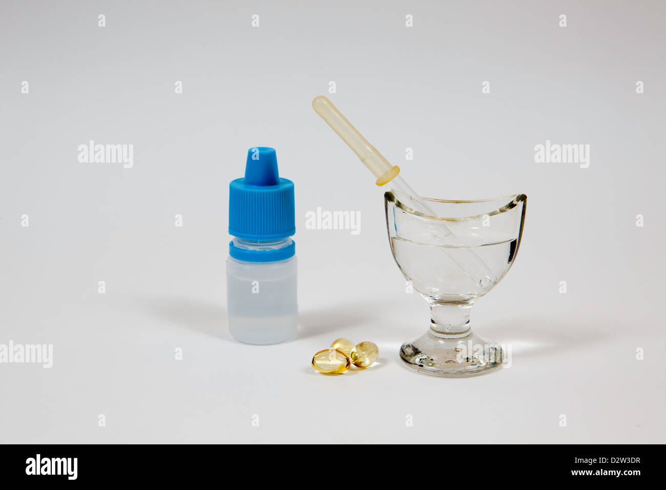 Medicine dropper, laboratory flask and vitamins on white background ...