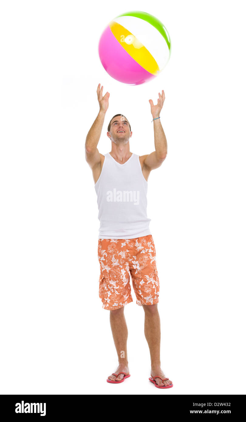Full length portrait of young man playing with beach ball Stock Photo ...