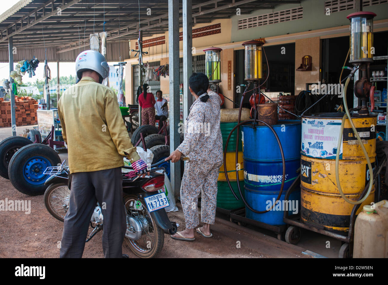 Filling up a motorcycle in Cambodia from gas barrels and by a woman ...