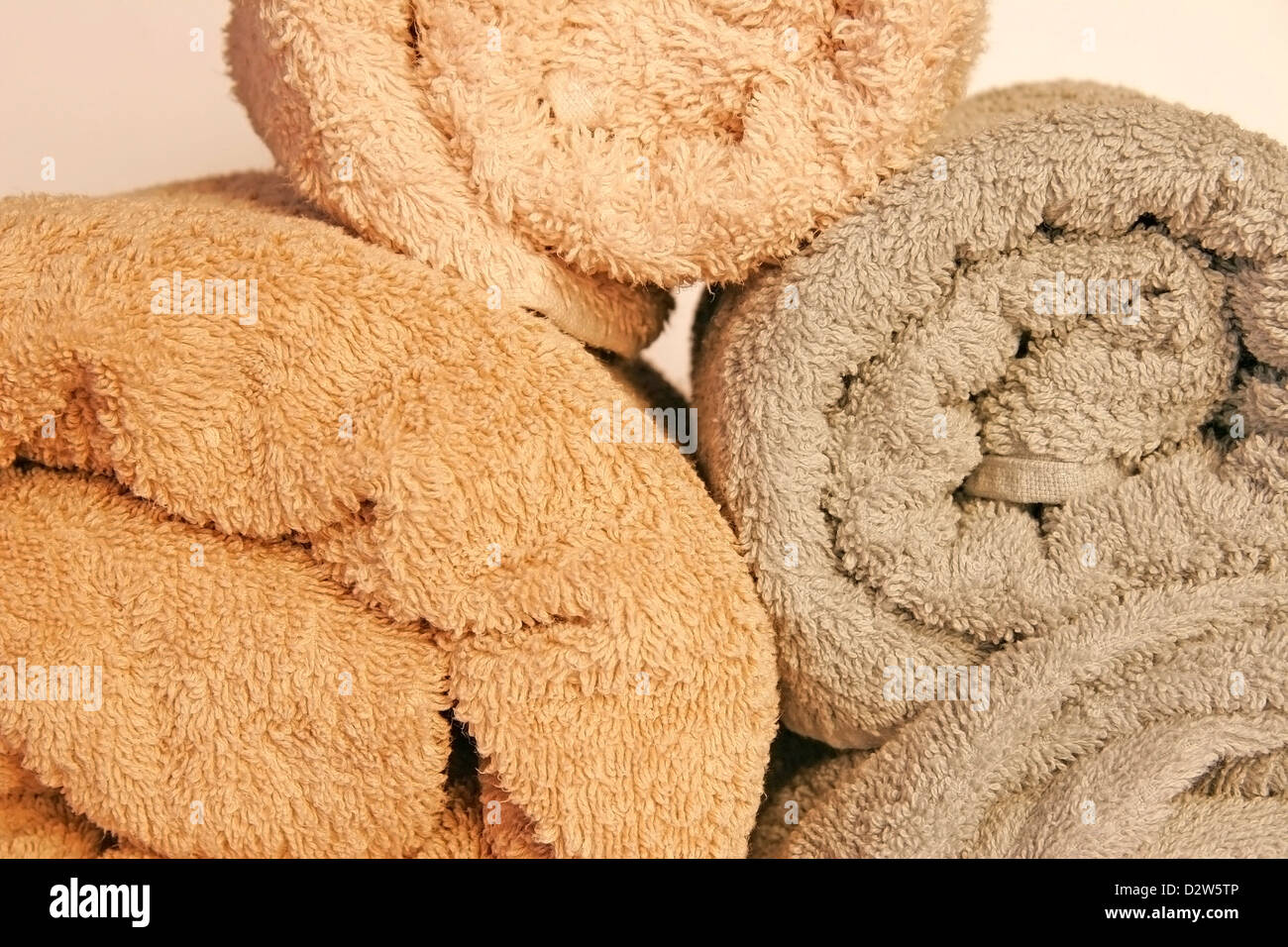 Rolled up spa towel on a calid background Stock Photo - Alamy