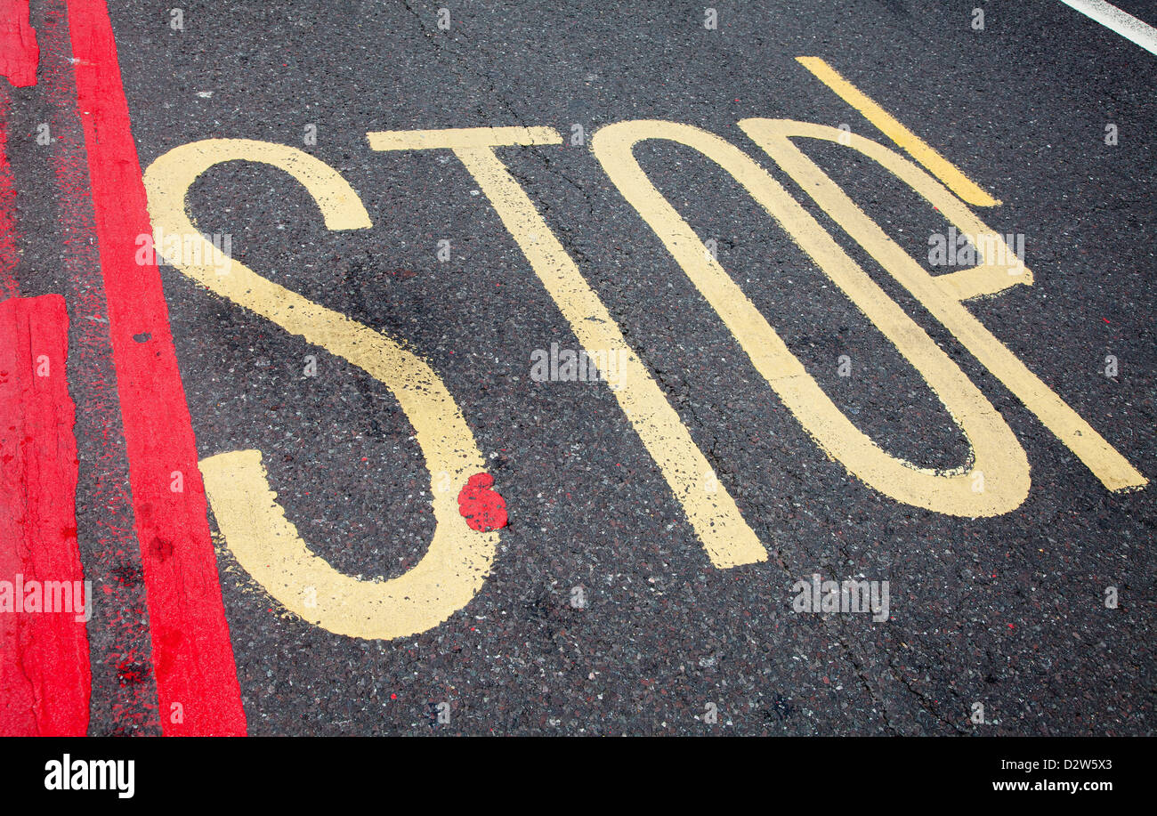 Stop sign road marking in London Stock Photo - Alamy