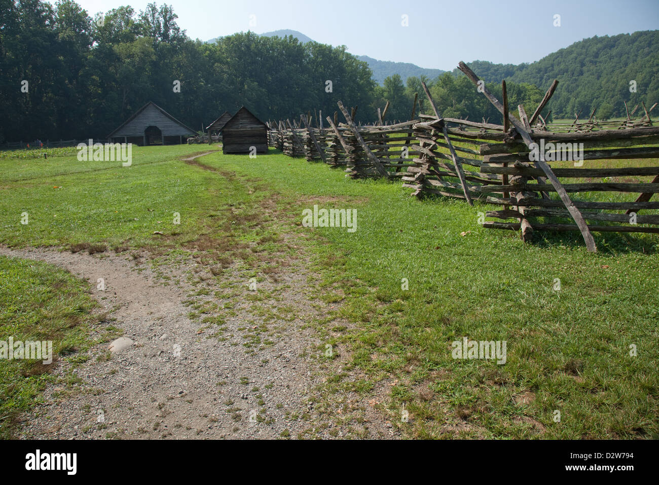 Worn path to the barn, past a split rail fence and a tool building ...