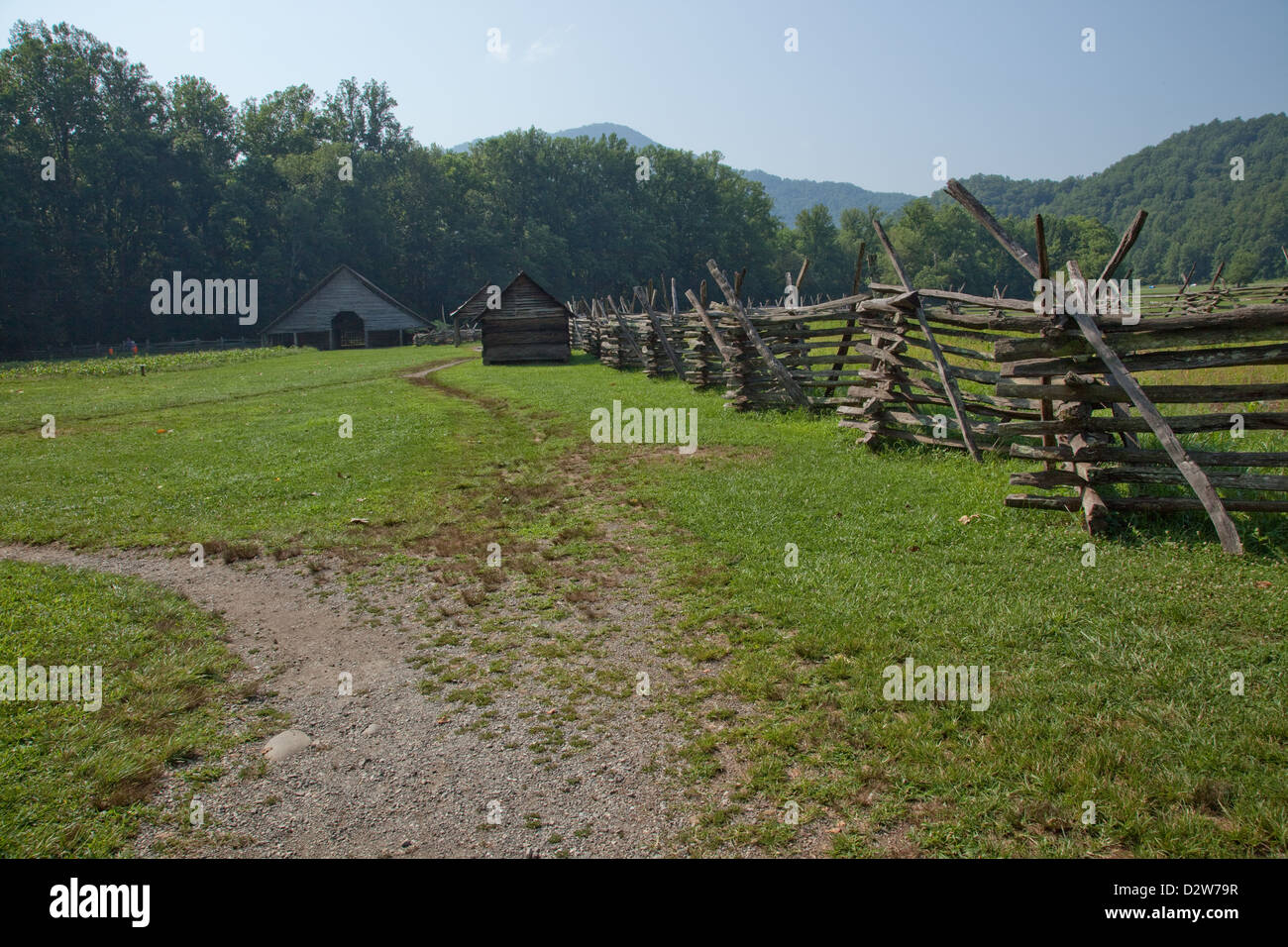 Worn path to the barn, past a split rail fence and a tool building ...