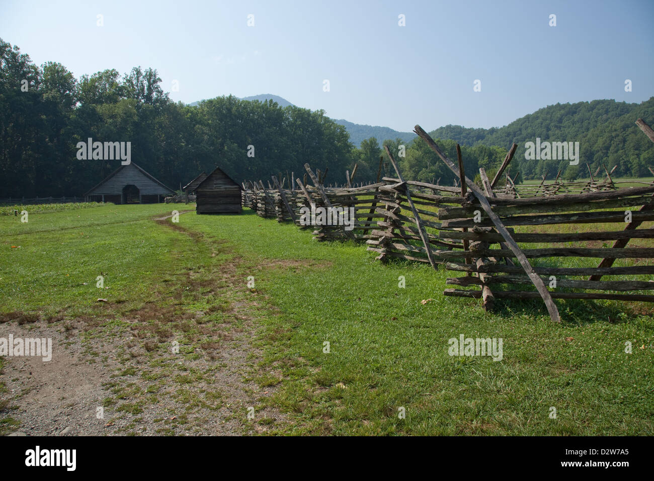 Worn path to the barn, past a split rail fence and a tool building ...