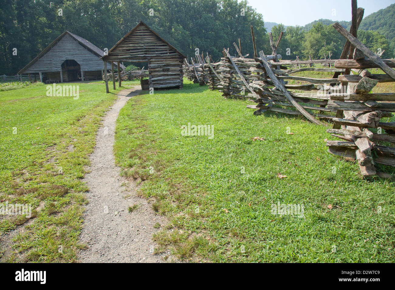 Worn path to the barn, past a split rail fence and a tool building ...