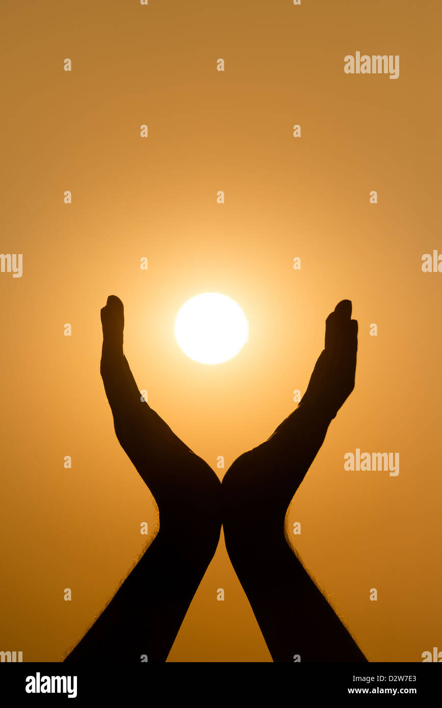 Hands holding the sun at yellow sunset background Stock Photo - Alamy