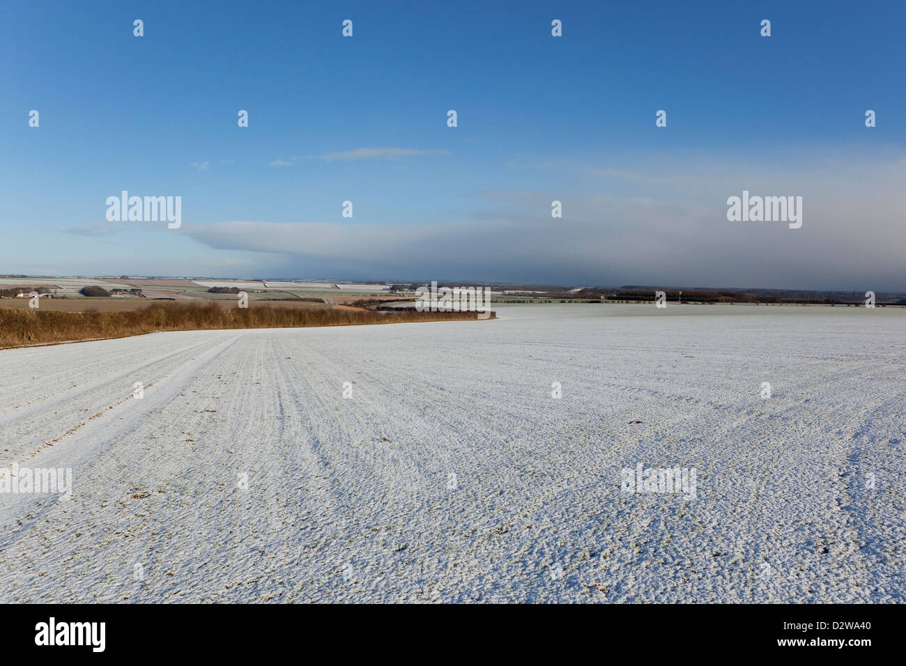 An English winter landscape with arable fields under a light covering ...