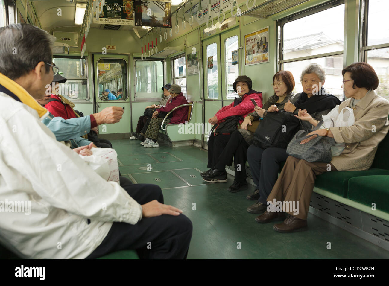 Senior passengers inside suburban commuter train, Kyoto, Japan Stock ...