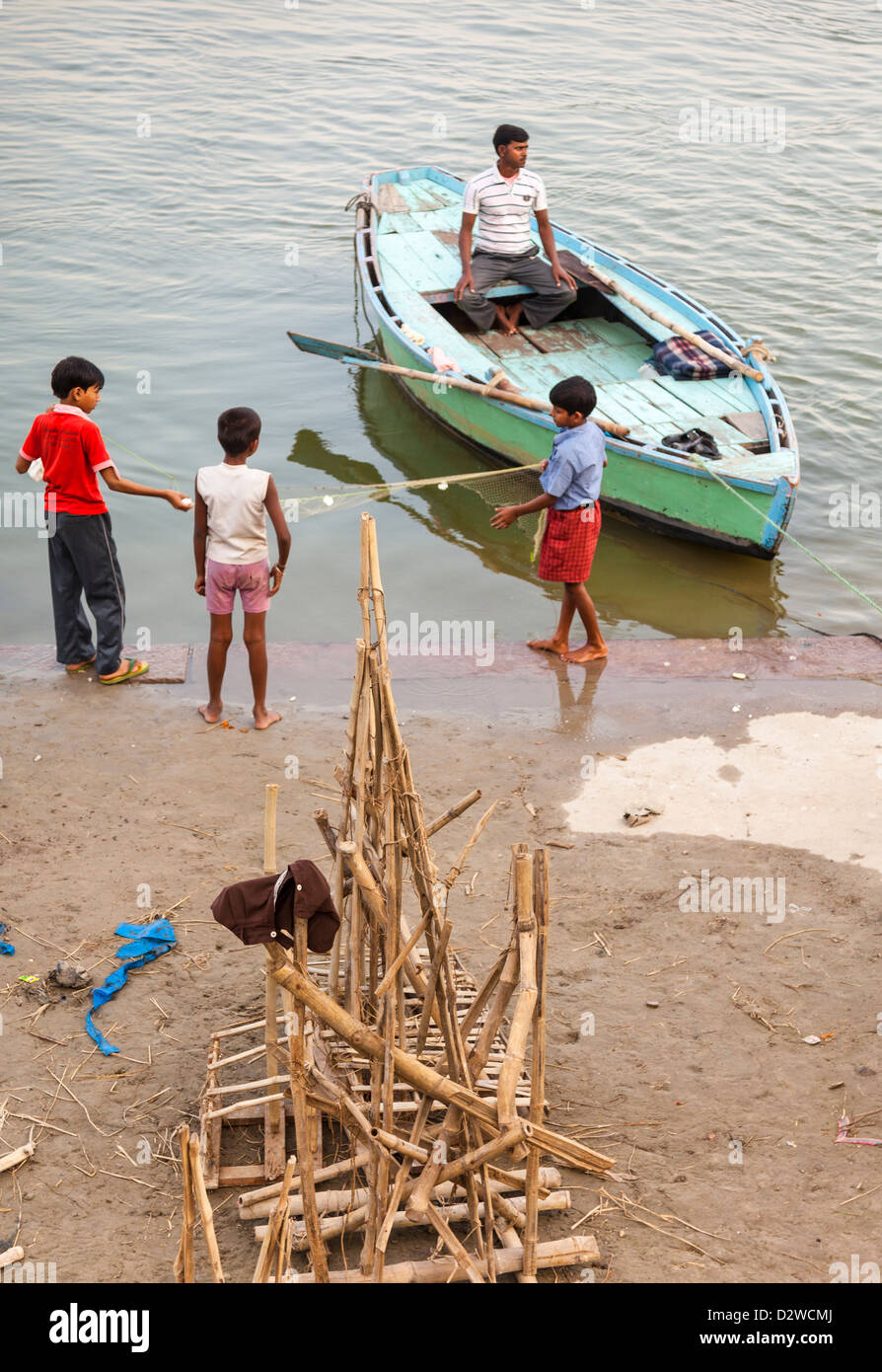 children playing on the banks of the Ganges river, Varanasi, India ...