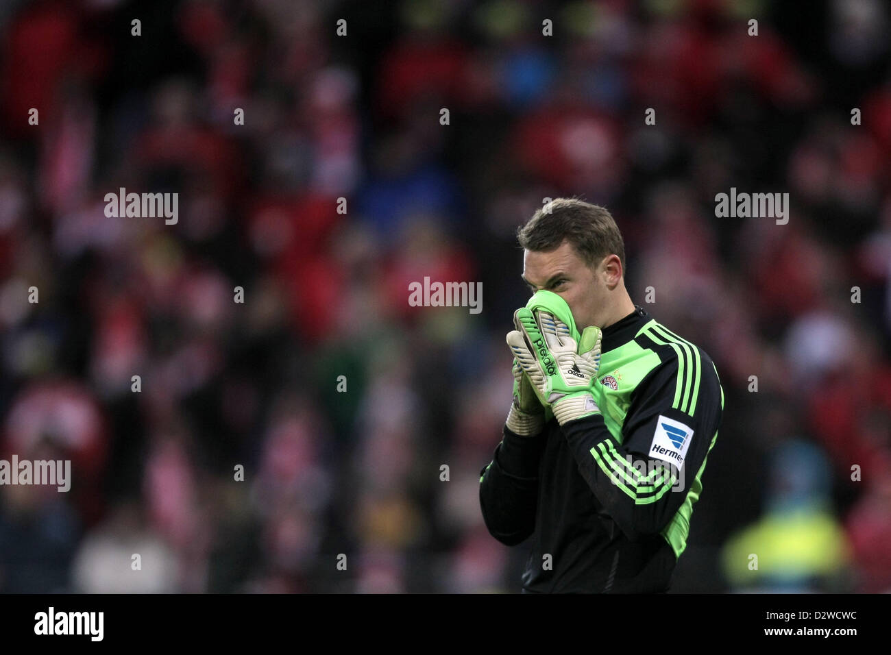 Munich's goalkeeper Manuel Neuer blows his nose during the Bundesliga ...