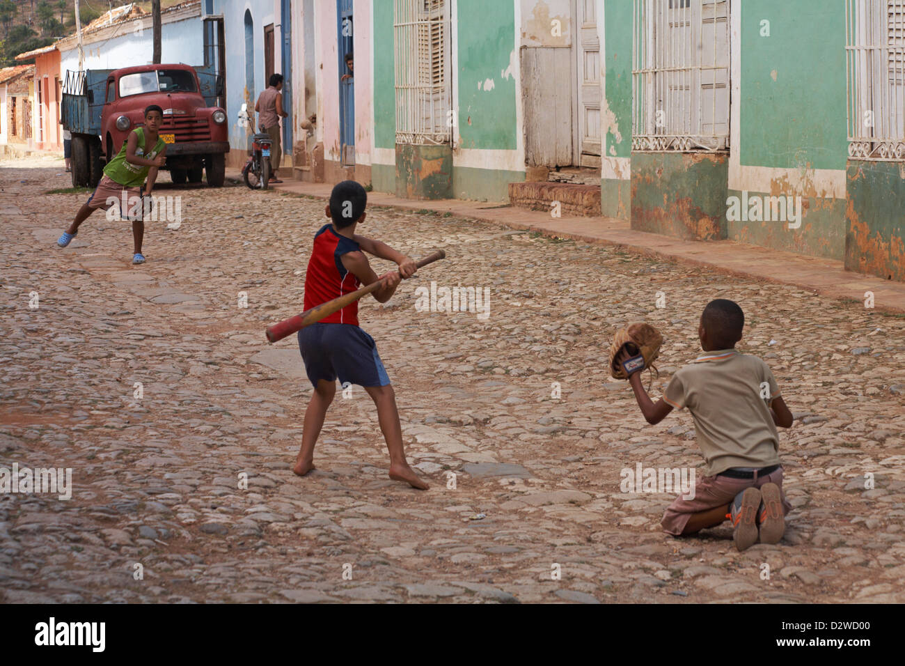 Daily life in Cuba - young lads playing baseball sport in the street ...