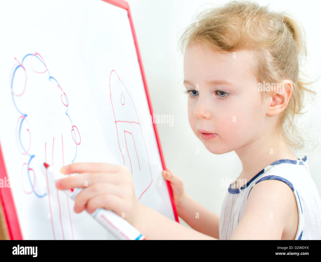 Pretty little girl writing with red marker on a whiteboard Stock Photo ...