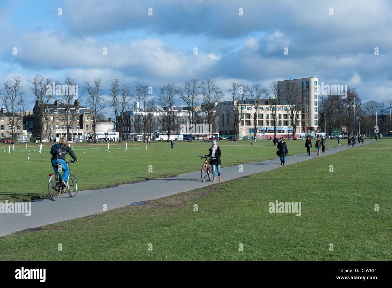 People walking and cycling across paths on Parker's Piece Cambridge UK ...