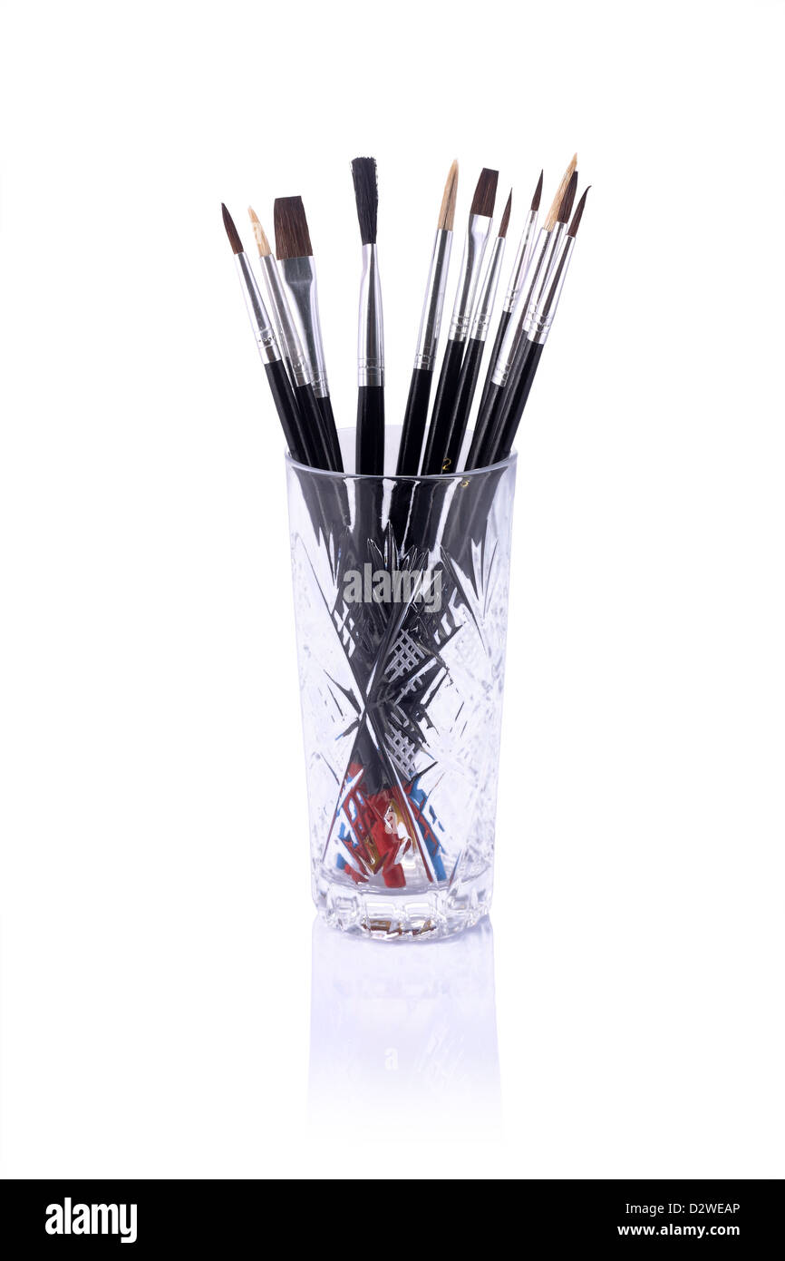 Painting brushes in glass isolated on white background Stock Photo - Alamy