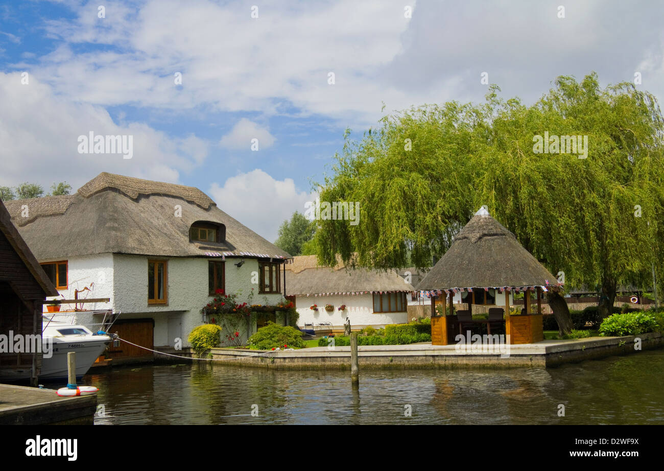 A luxurious cottage and a moored motor boat in the "driveway" on the ...