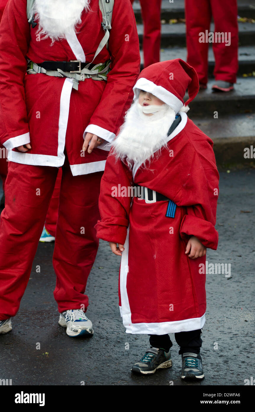 Young boy in Santa suit for the charity "Santa Run" in Princes Street ...