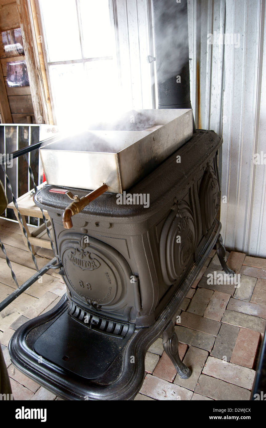 Metal pan full of boiling maple sap which will become maple syrup once ...