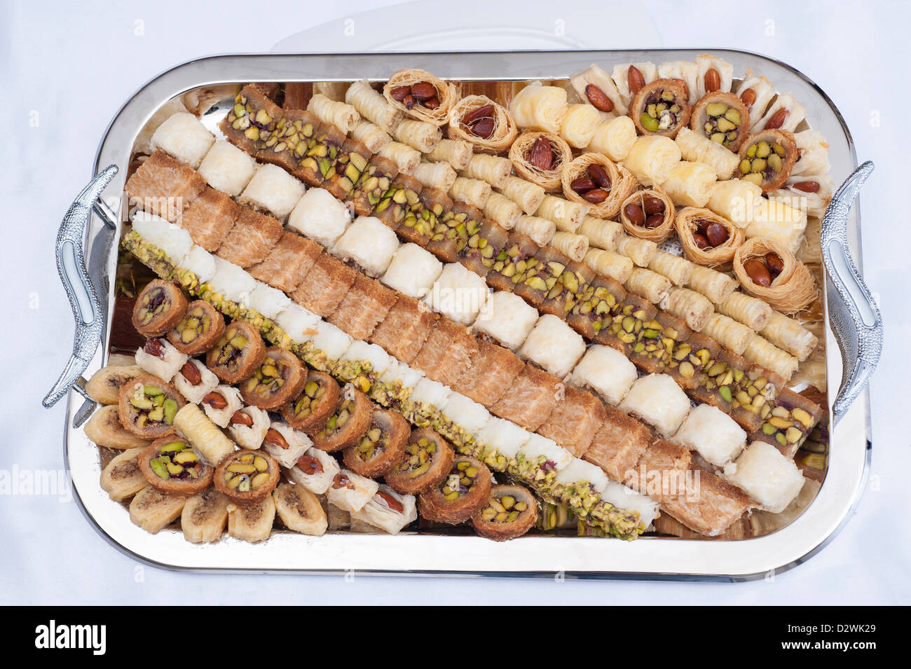 Selection of luxury oriental petit fours on a plate isolated on white ...