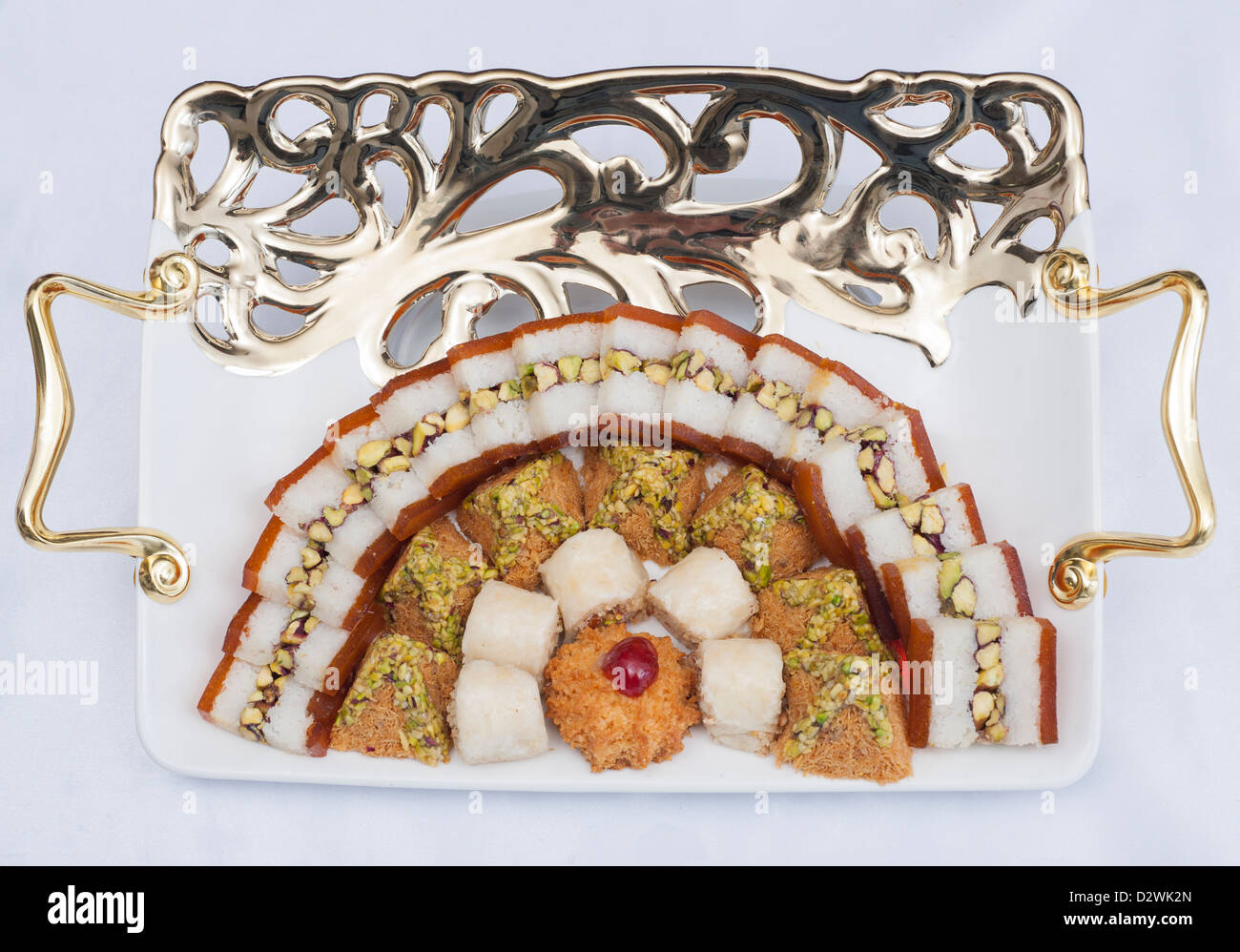 Selection of luxury oriental petit fours on a plate isolated on white ...