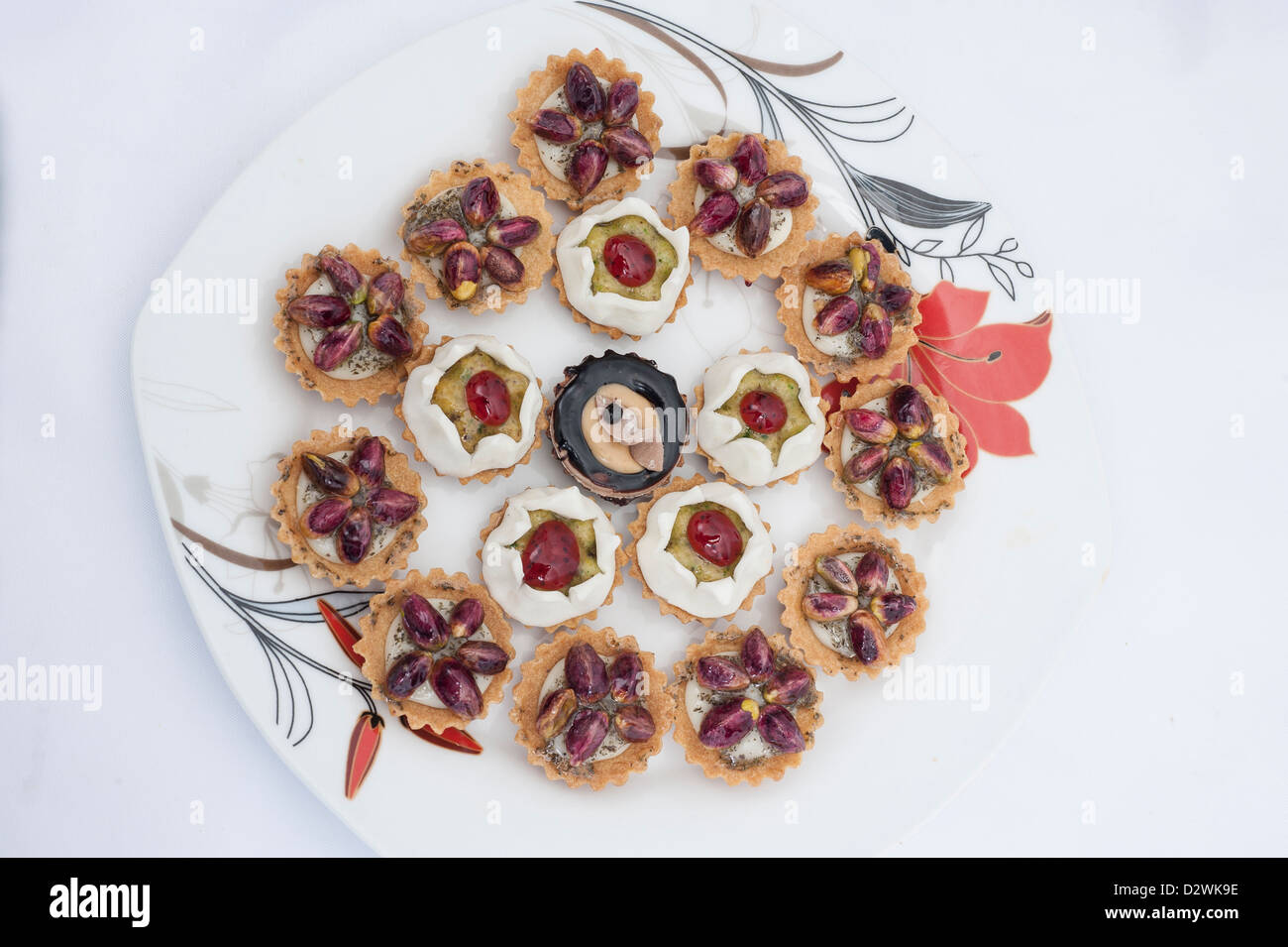 Selection of luxury oriental petit fours isolated on a white plate ...