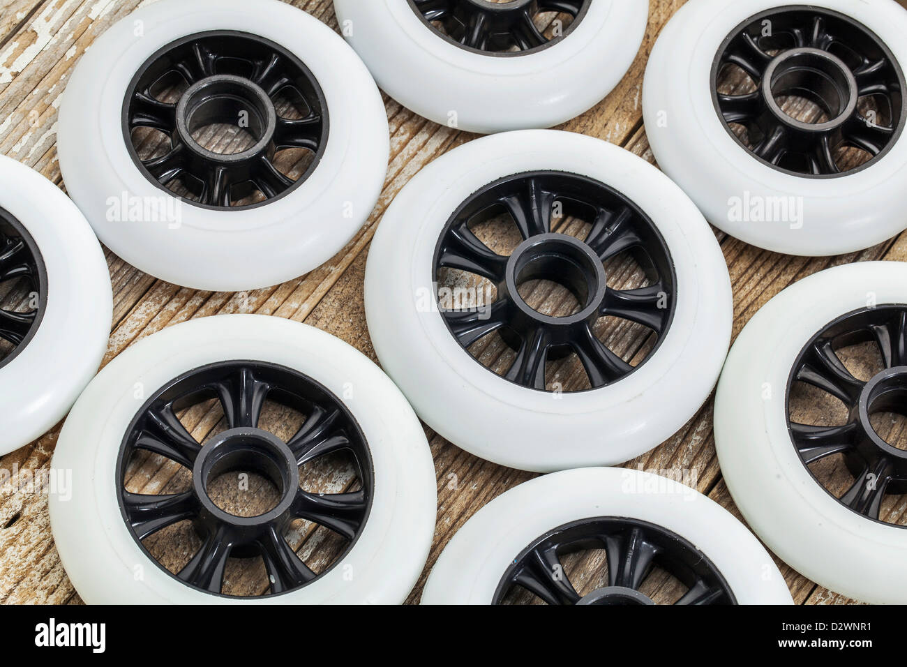 white racing wheels for inline skating on wooden surface Stock Photo ...