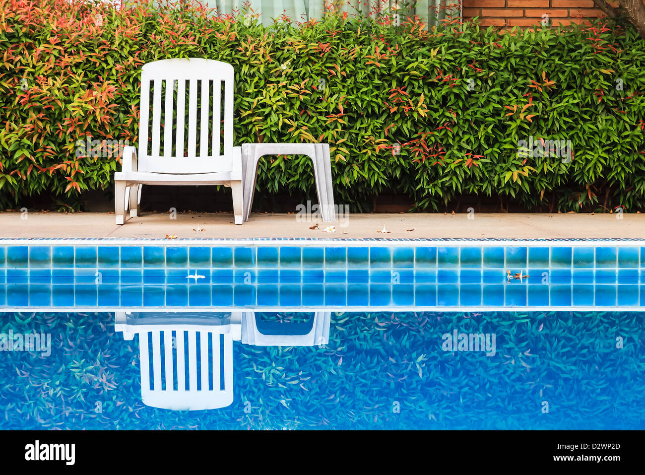 White chair and swimming pool, front view Stock Photo - Alamy