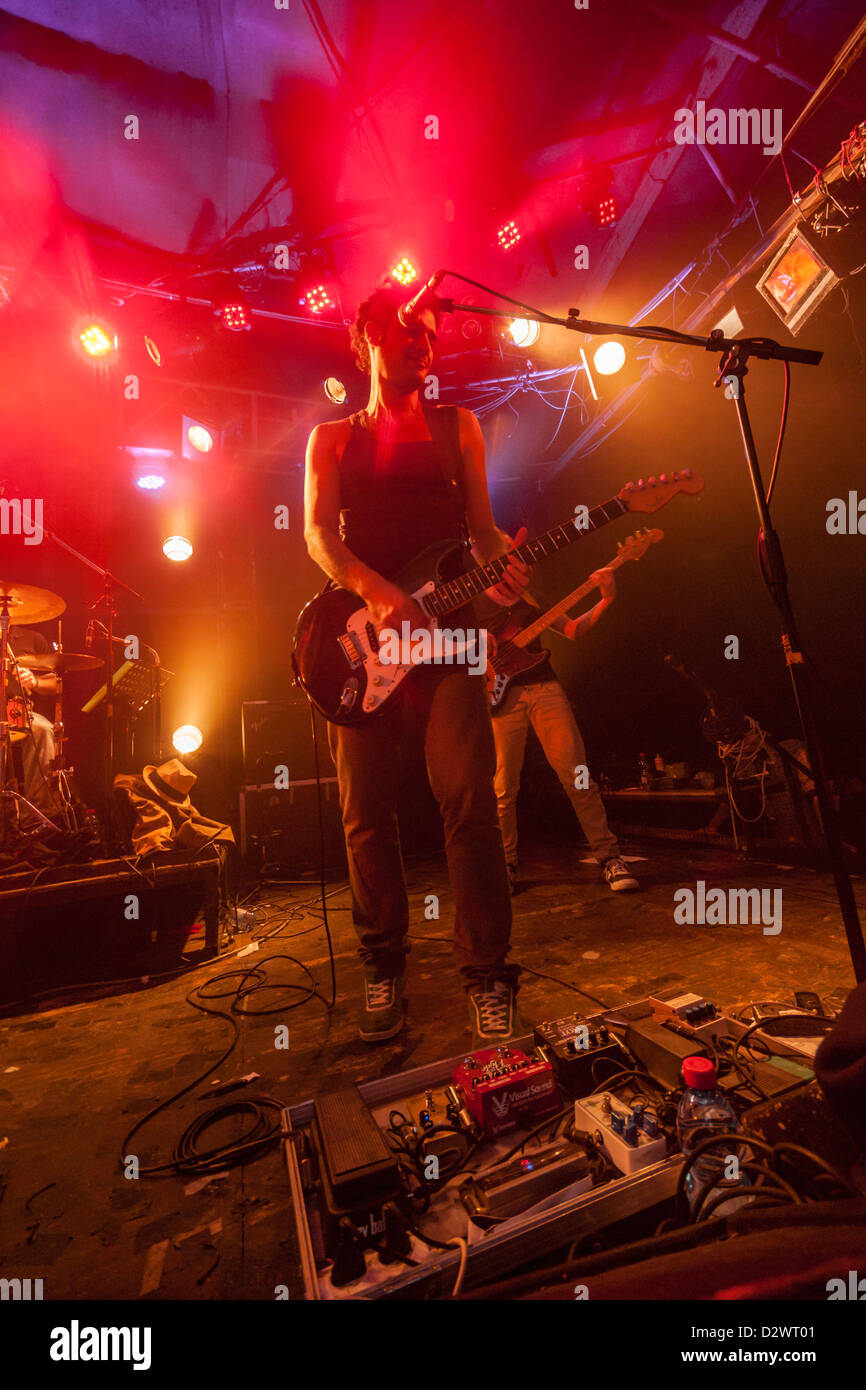 Israel. A rock band performs in a nightclub. Guitar effect boxes in the ...