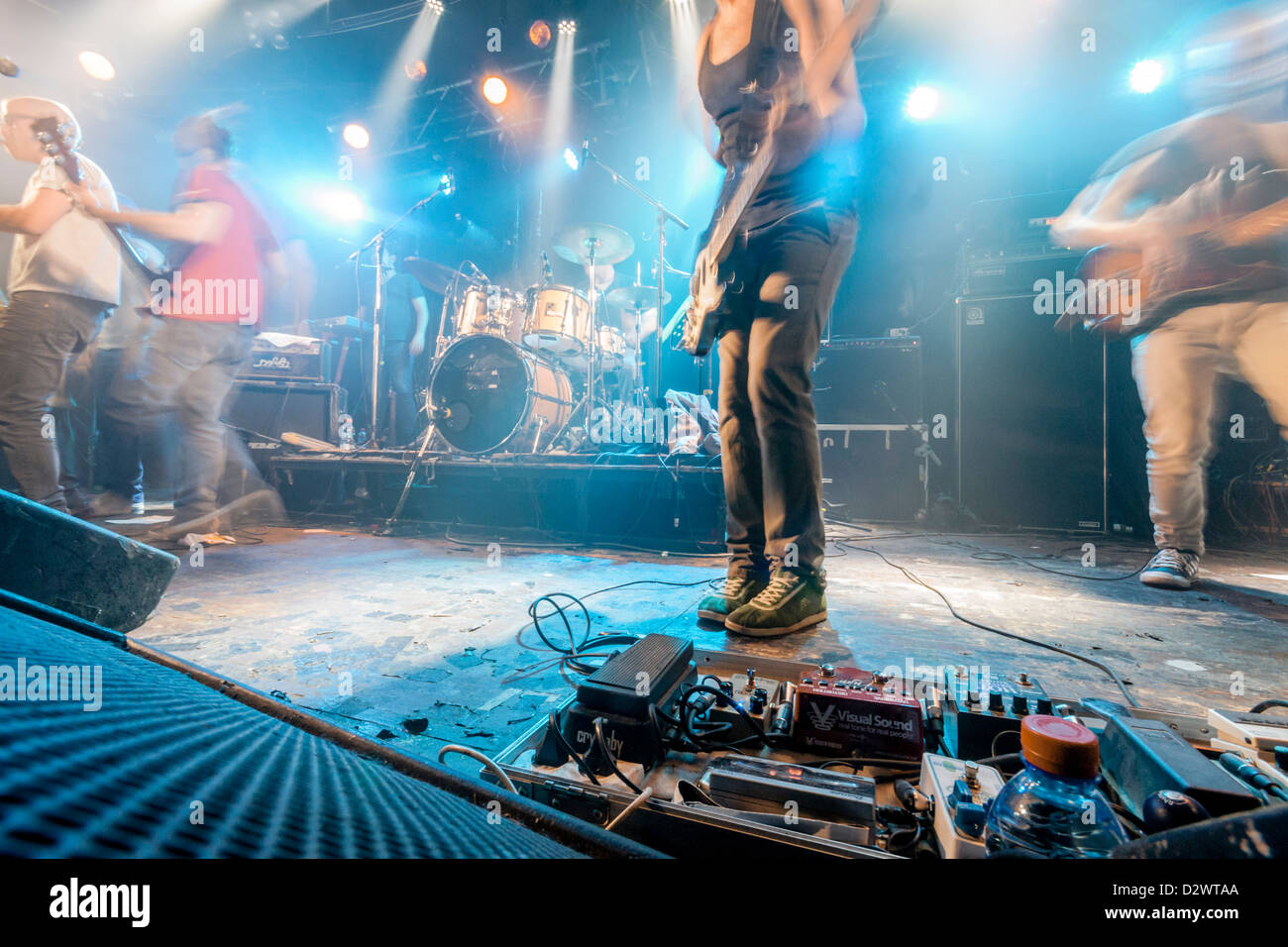 Israel. A rock band performs in a nightclub. Guitar effect boxes in the ...