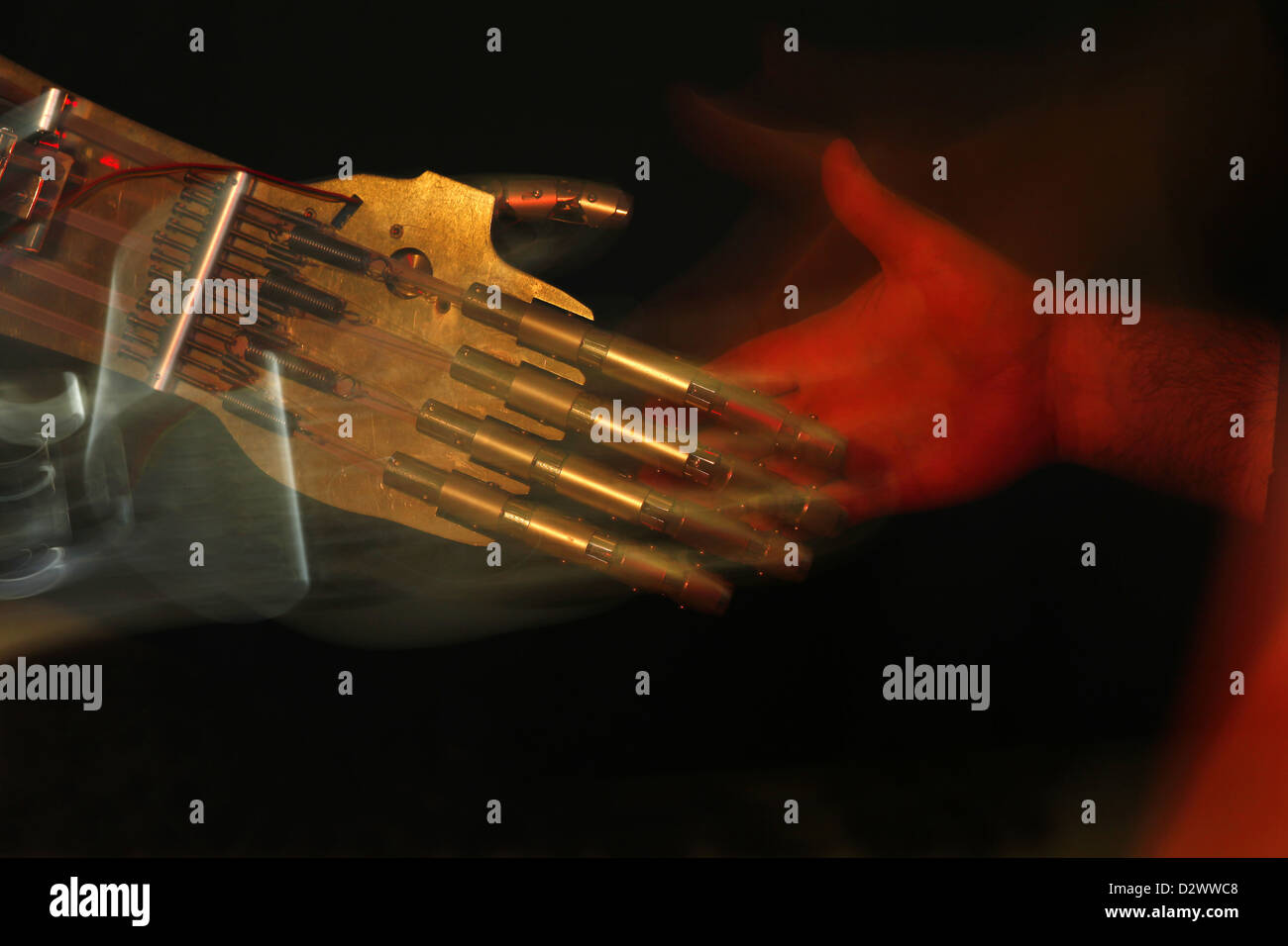 Berlin, Germany, Bionic hand and human hand Stock Photo - Alamy