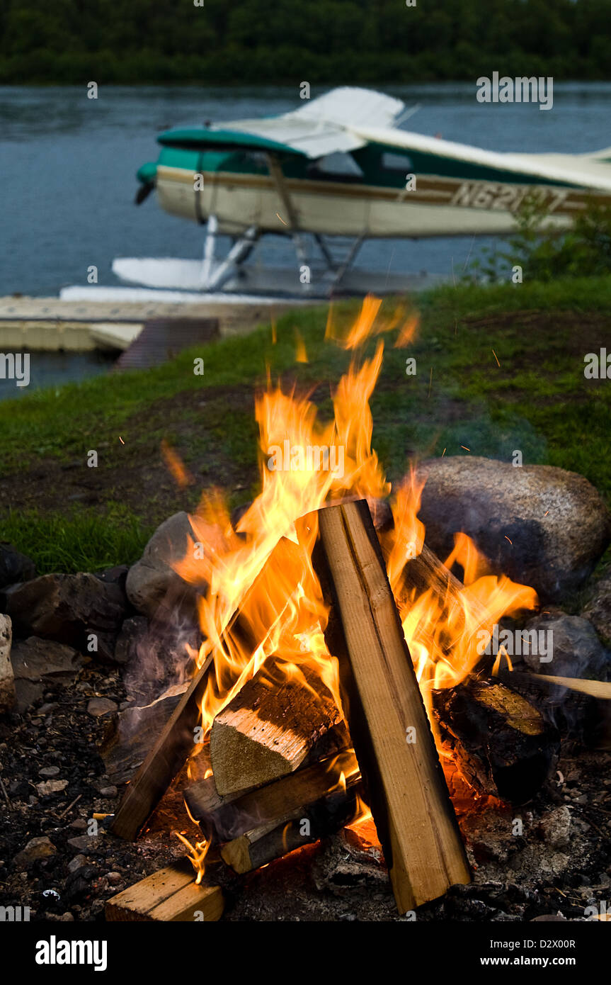 DeHavilland Beaver floatplane docked in front of a roaring campfire ...