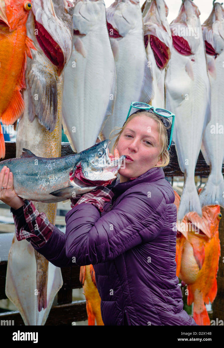 Charter boat fisher woman happily kisses fresh catch of the day for the ...