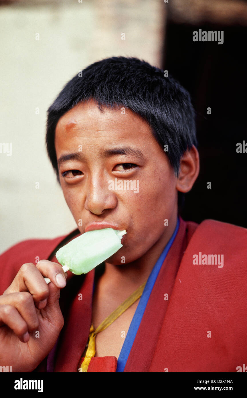 Young Tibetan Buddhist monk eating ice-cream Stock Photo - Alamy