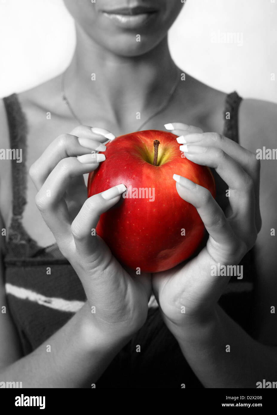 The girl holds in hands red an apple. Partial decolouration Stock Photo ...