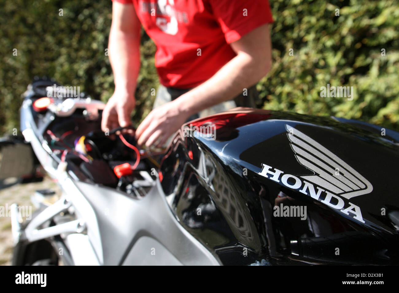 Berlin, Germany, a man working on a motorcycle Stock Photo - Alamy