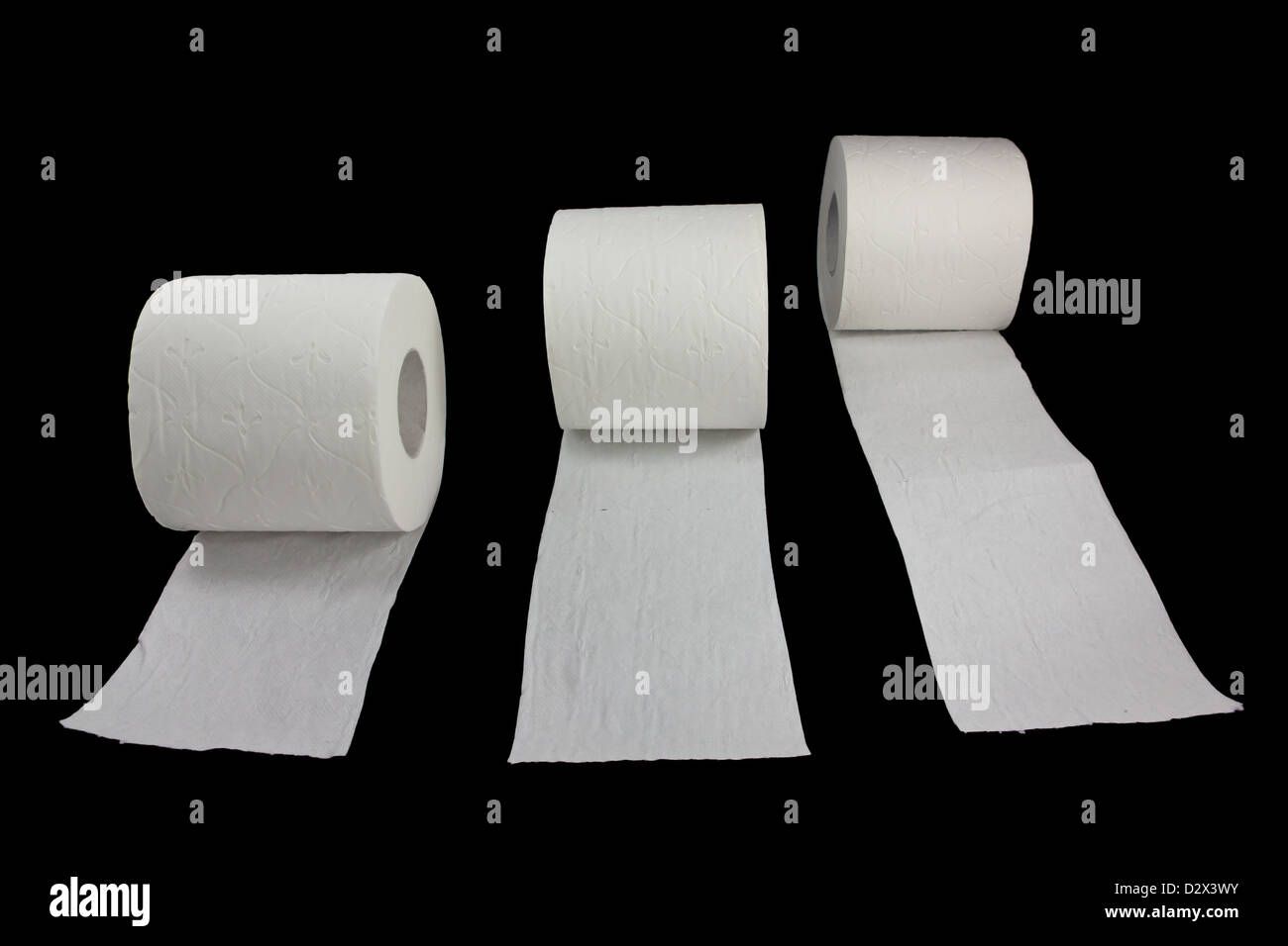 Picture of three toilet rolls racing on a black background Stock Photo ...