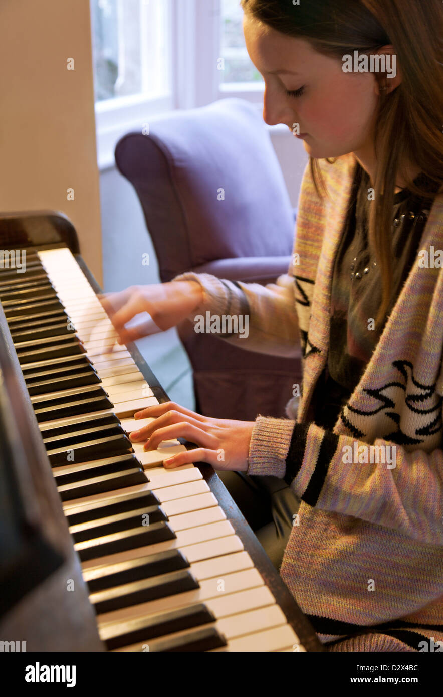 Teenage girl playing piano hi-res stock photography and images - Alamy