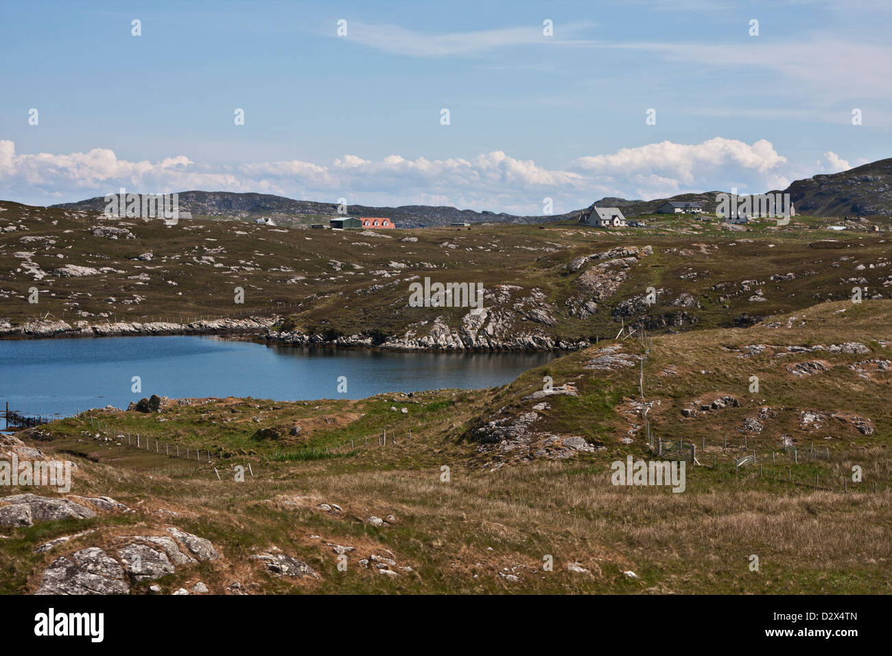 A small alke or loch and cottages in the highlands of the Isle of Barra ...