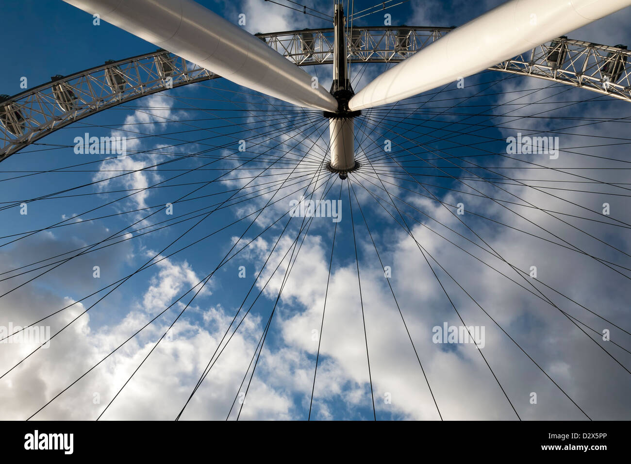 The famous London eye in detail, over a blue cloudy sky. It is one of ...