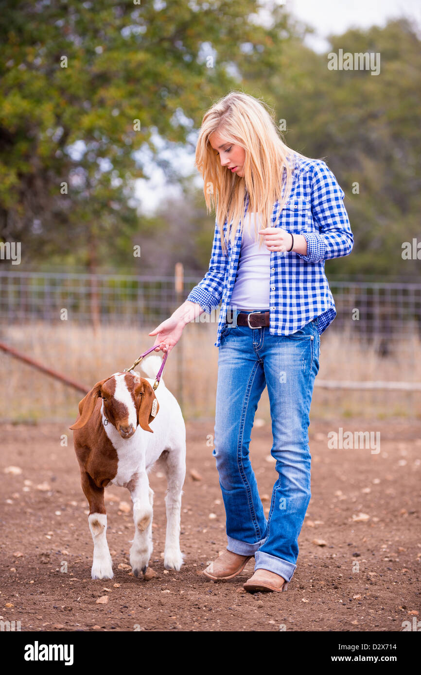 Girl walking goat on livestock farm Stock Photo - Alamy