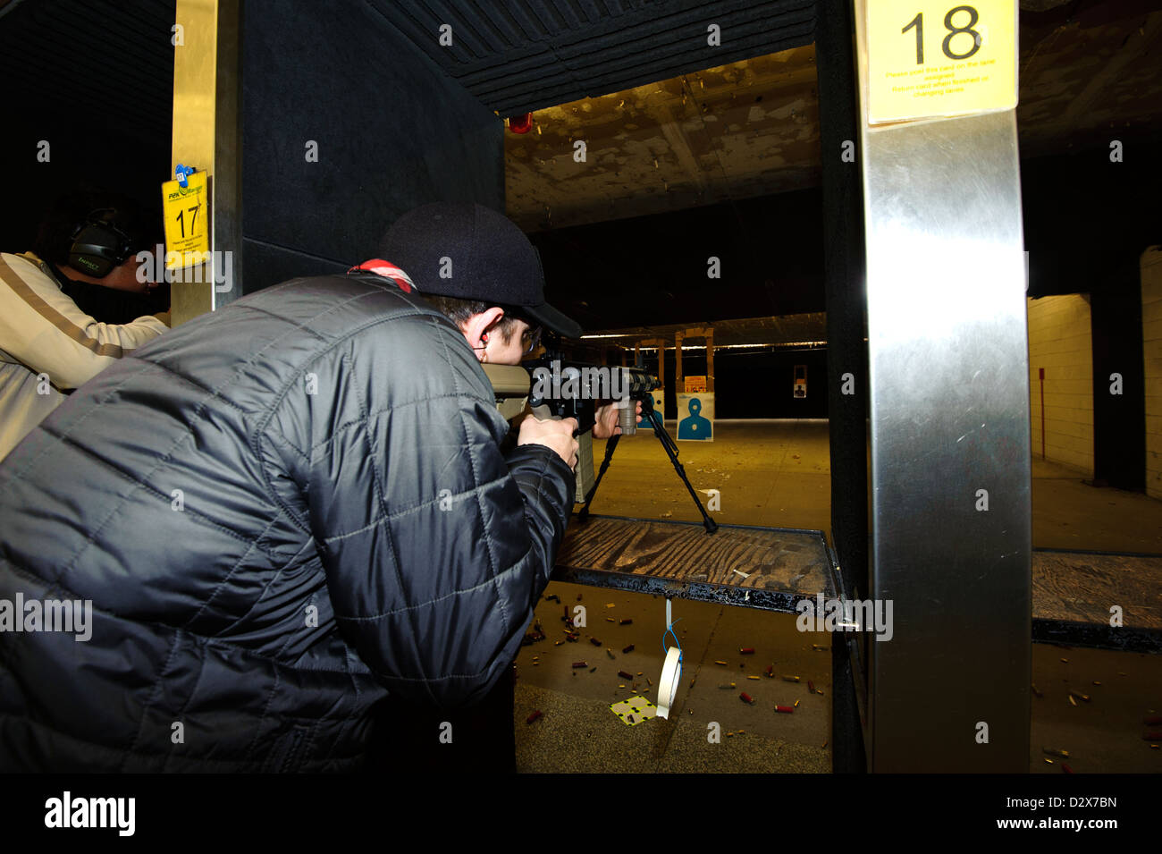 Target shooting with an AR-style target rifle at an indoor range Stock ...