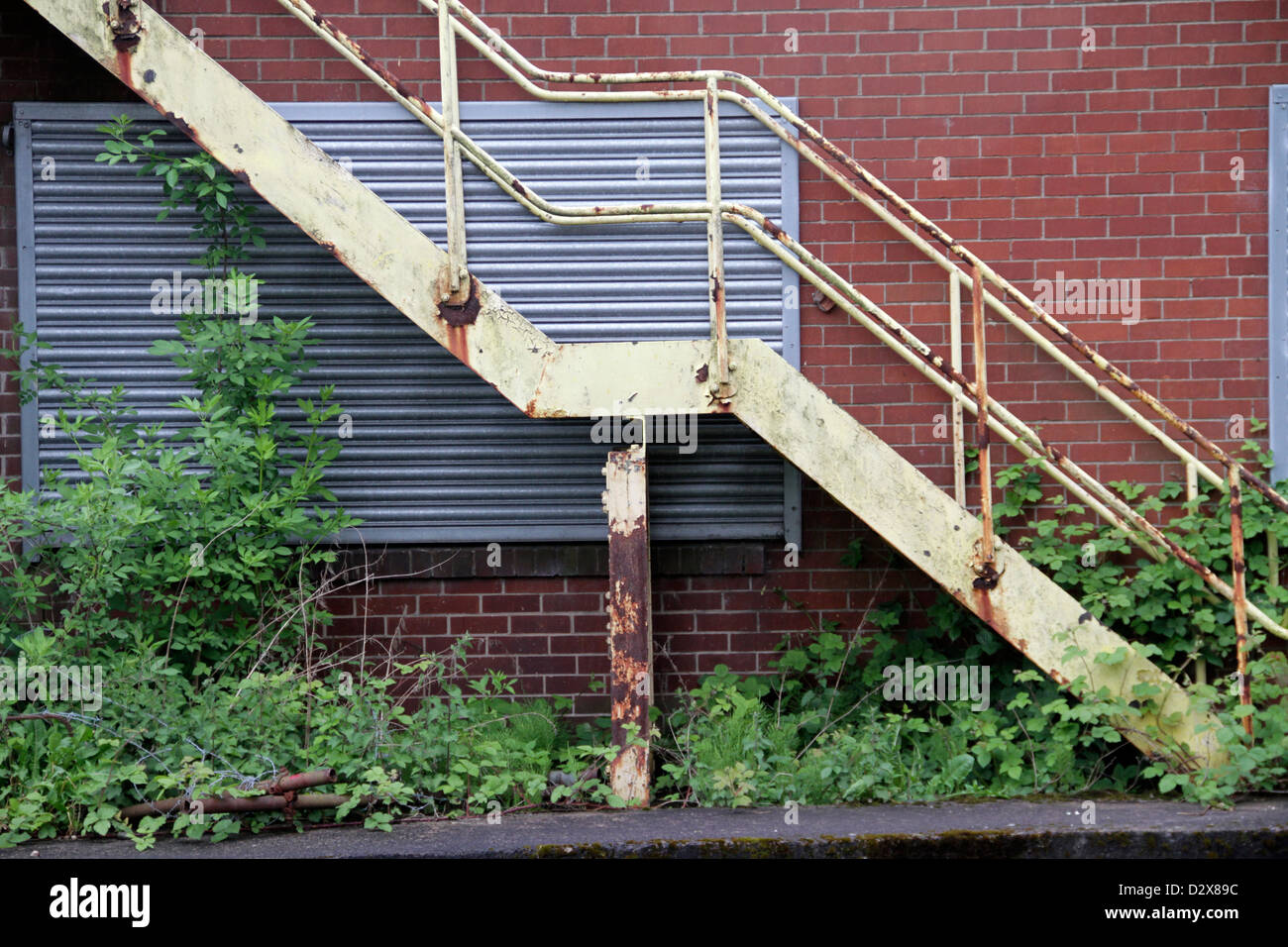 Rusty fire escape on side of a red brick building Stock Photo - Alamy