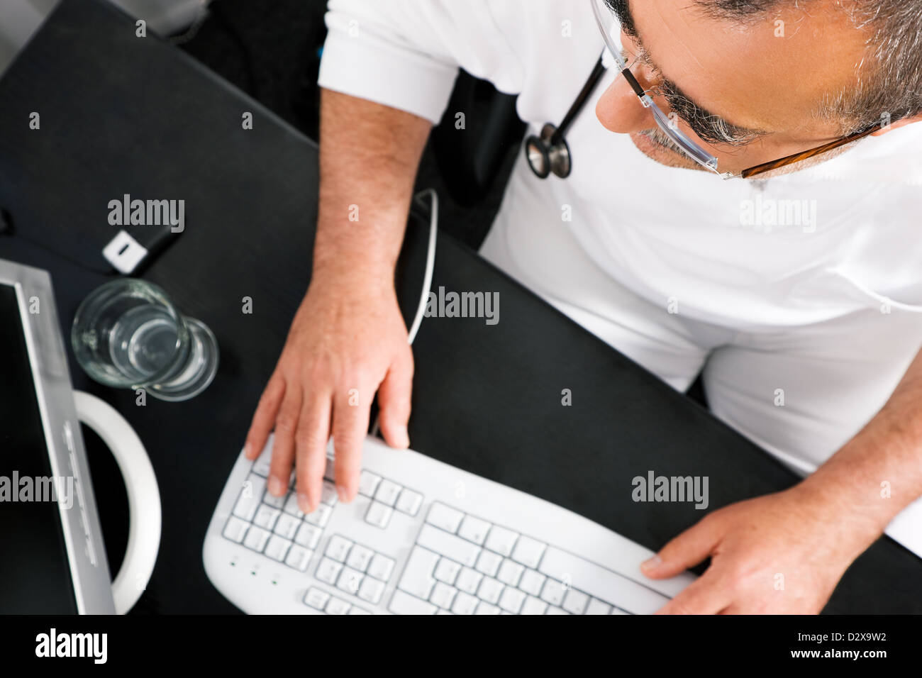 Doctor working at the PC Stock Photo - Alamy